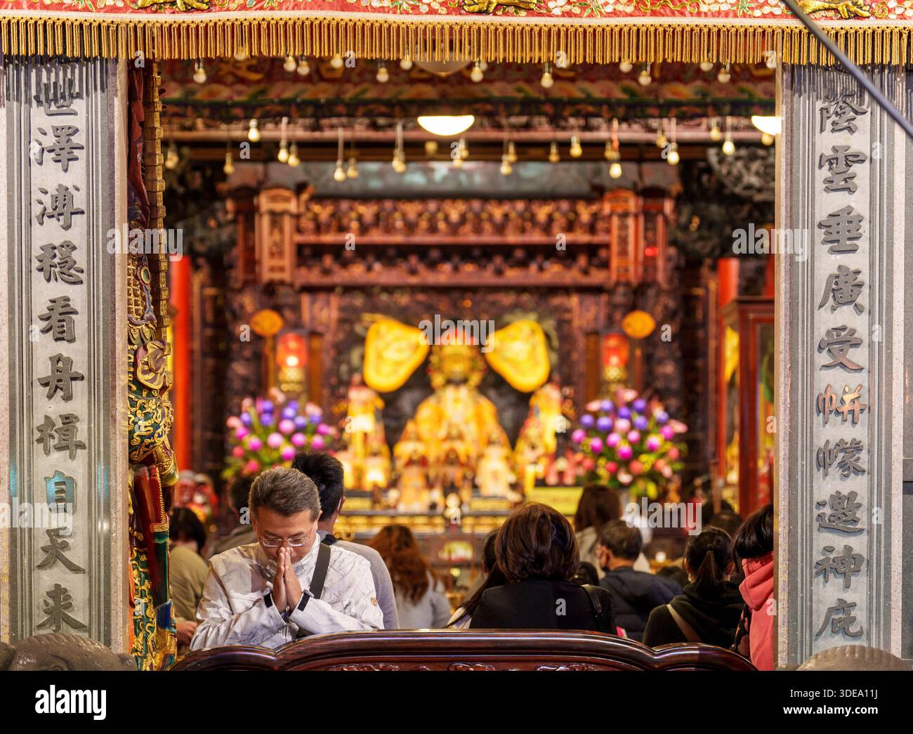 29 November 2024, Taiwan, Taipeh: A Buddhist stands with folded hands ...