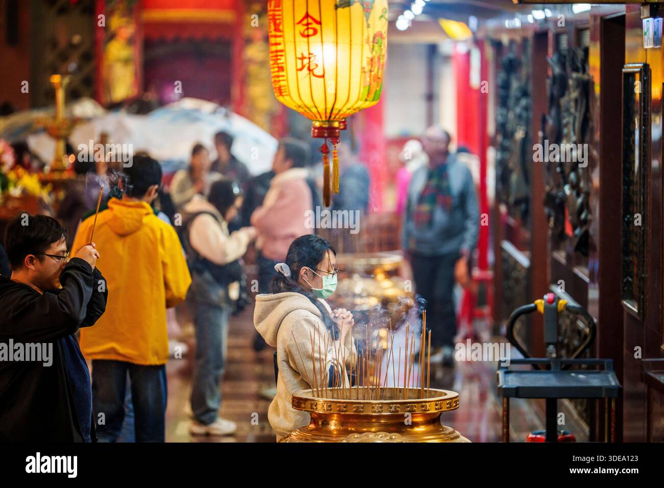 29 November 2024, Taiwan, Taipeh: A Buddhist woman stands with folded ...