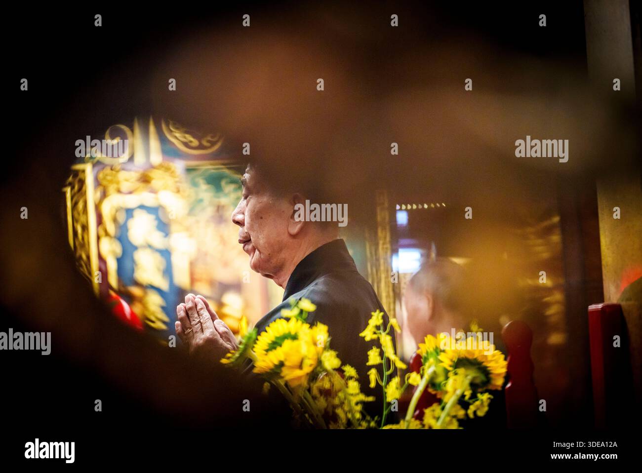 29 November 2024, Taiwan, Taipeh: A Buddhist woman stands with folded ...