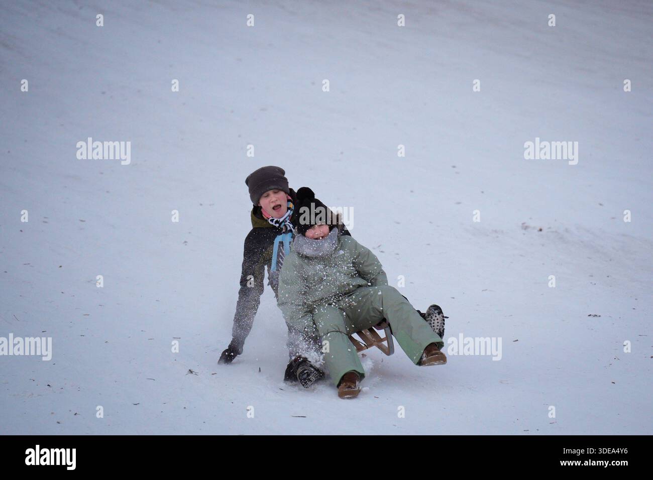 People enjoy the snow and are seen sledding in the Ujazdowskie Park in ...