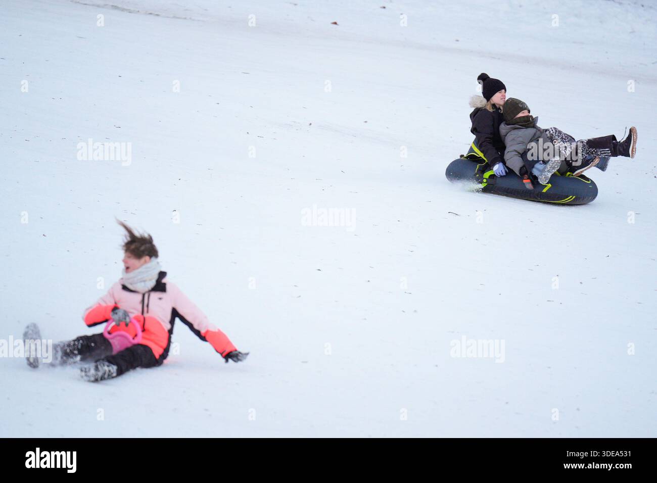 People enjoy the snow and are seen sledding in the Ujazdowskie Park in ...