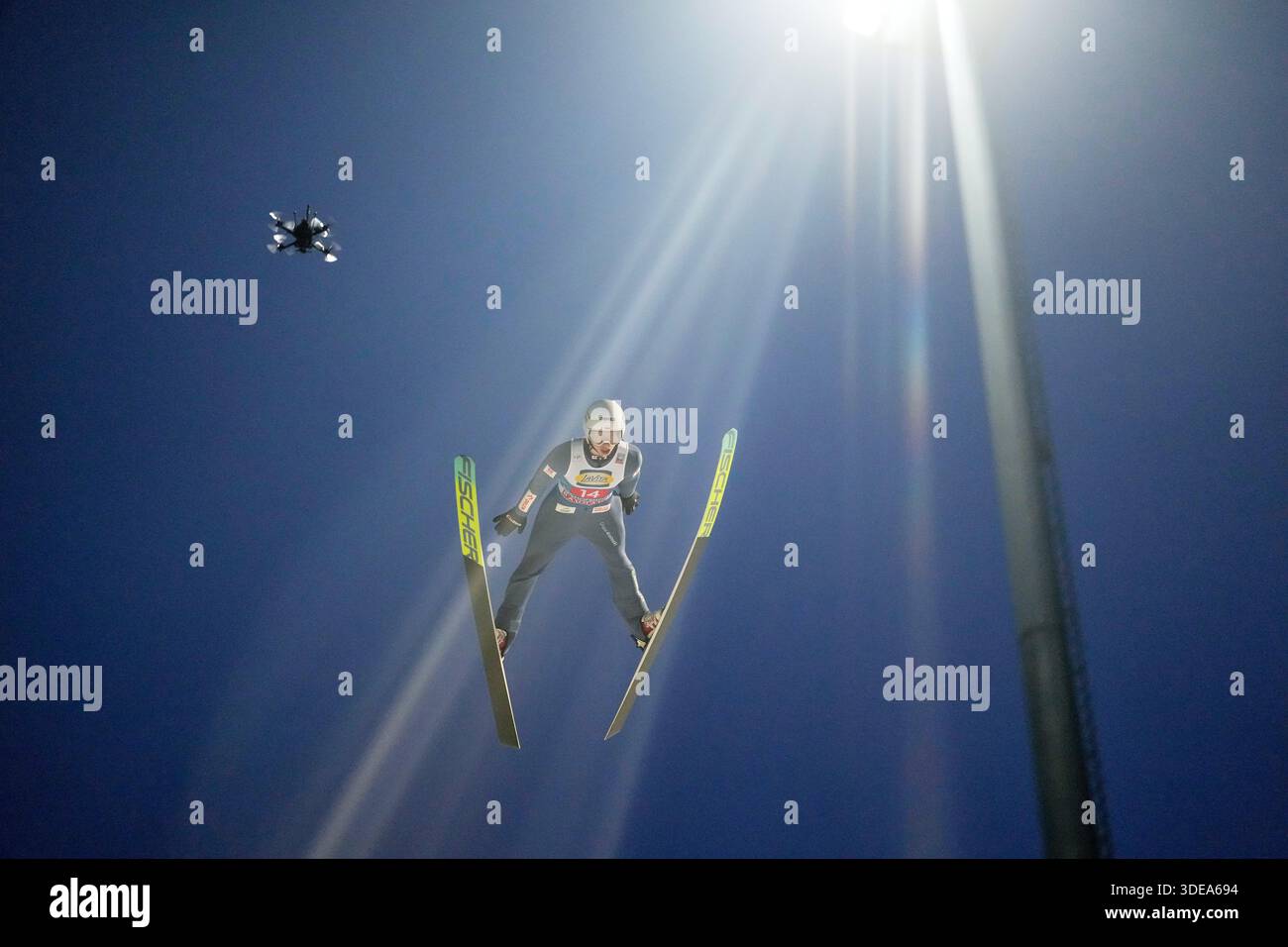 Kacper Tomasiak, of Poland, soars through the air during his first ...