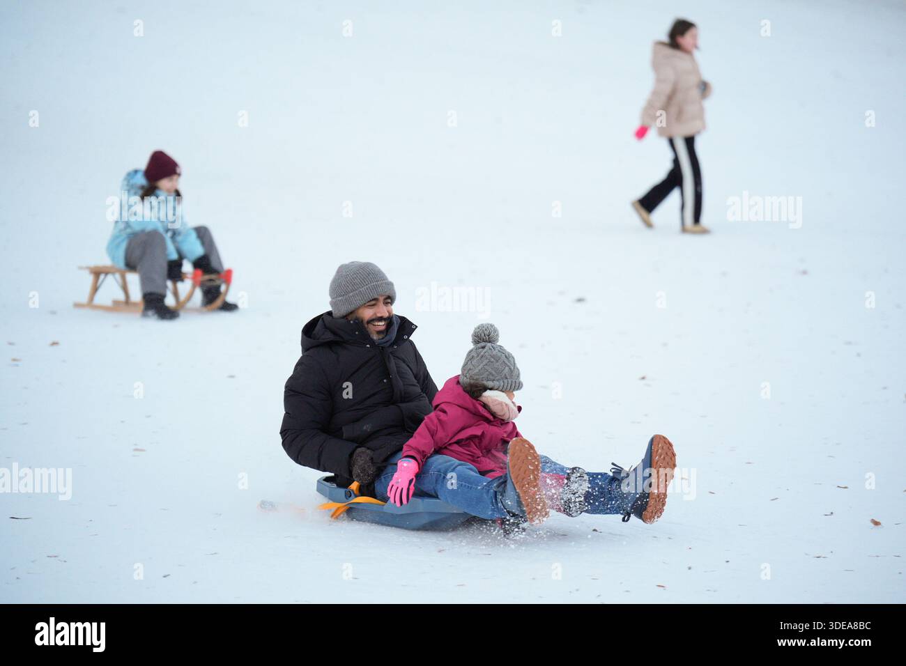 People enjoy the snow and are seen sledding in the Ujazdowskie Park in ...