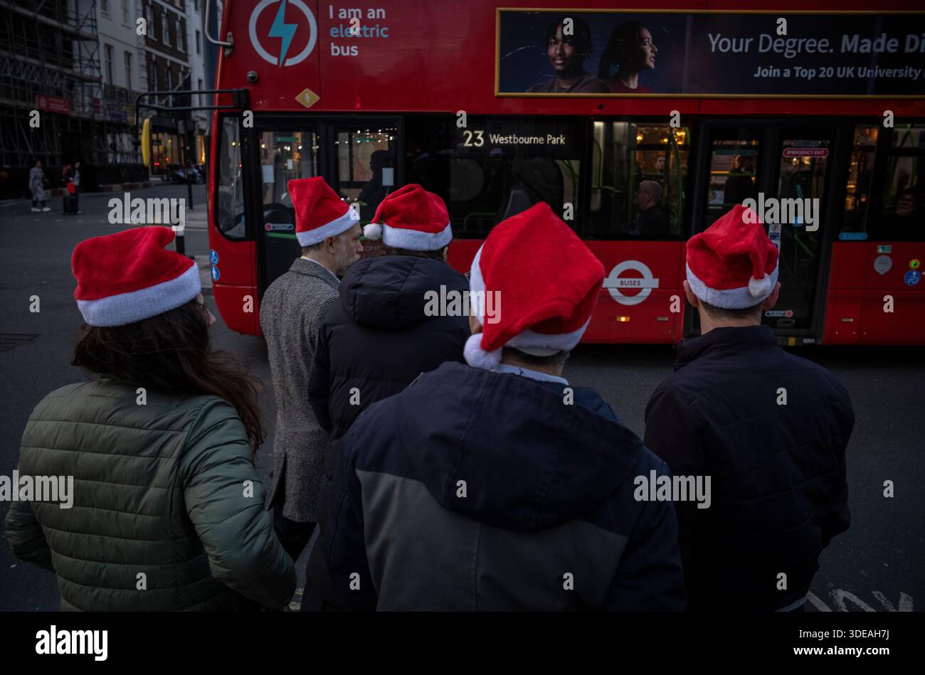 Work colleagues wearing santa claus hats hi-res stock photography and ...