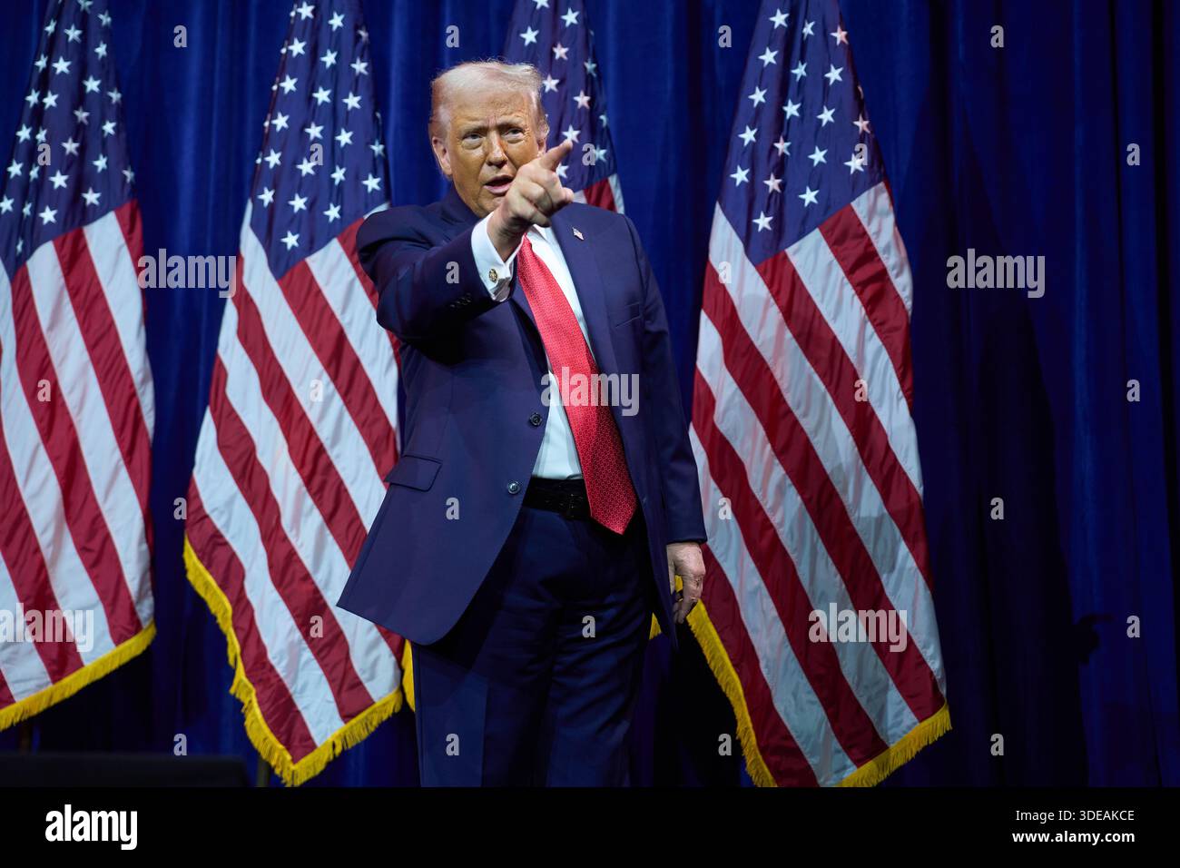 President Donald Trump points to the crowd as he walks off stage after ...