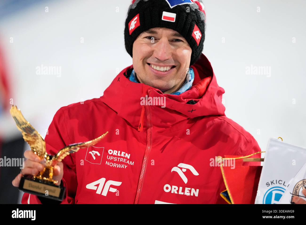 Kamil Stoch, of Poland, who is retiring, smiles after receiving an ...