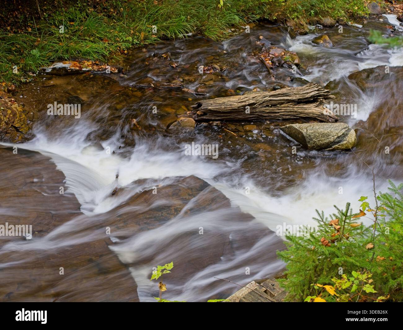 Flowing river water over rocky river bed of Sable Falls at Pictured ...