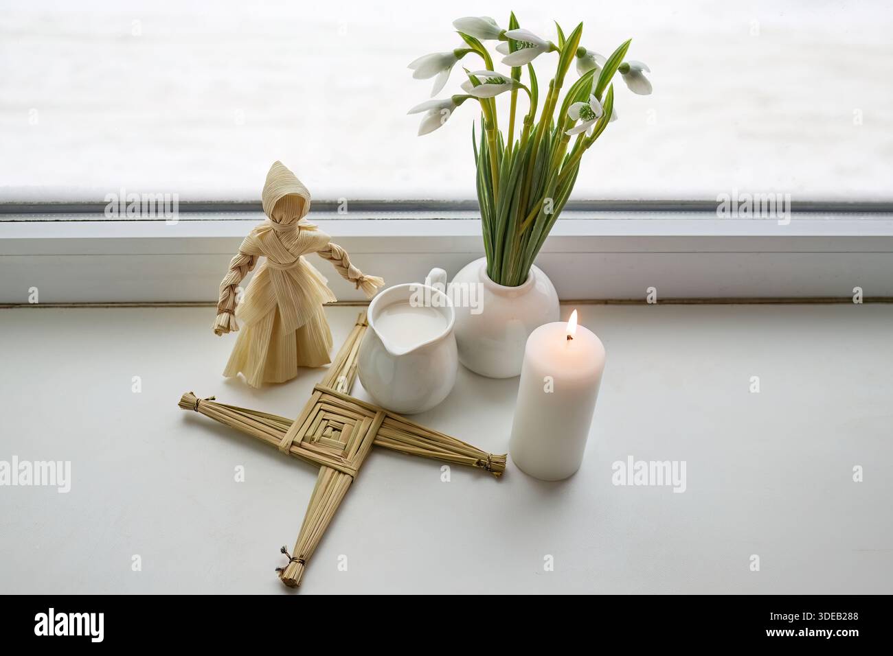 Imbolc altar with brigid doll, cross, snowdrops, candle, milk Stock ...