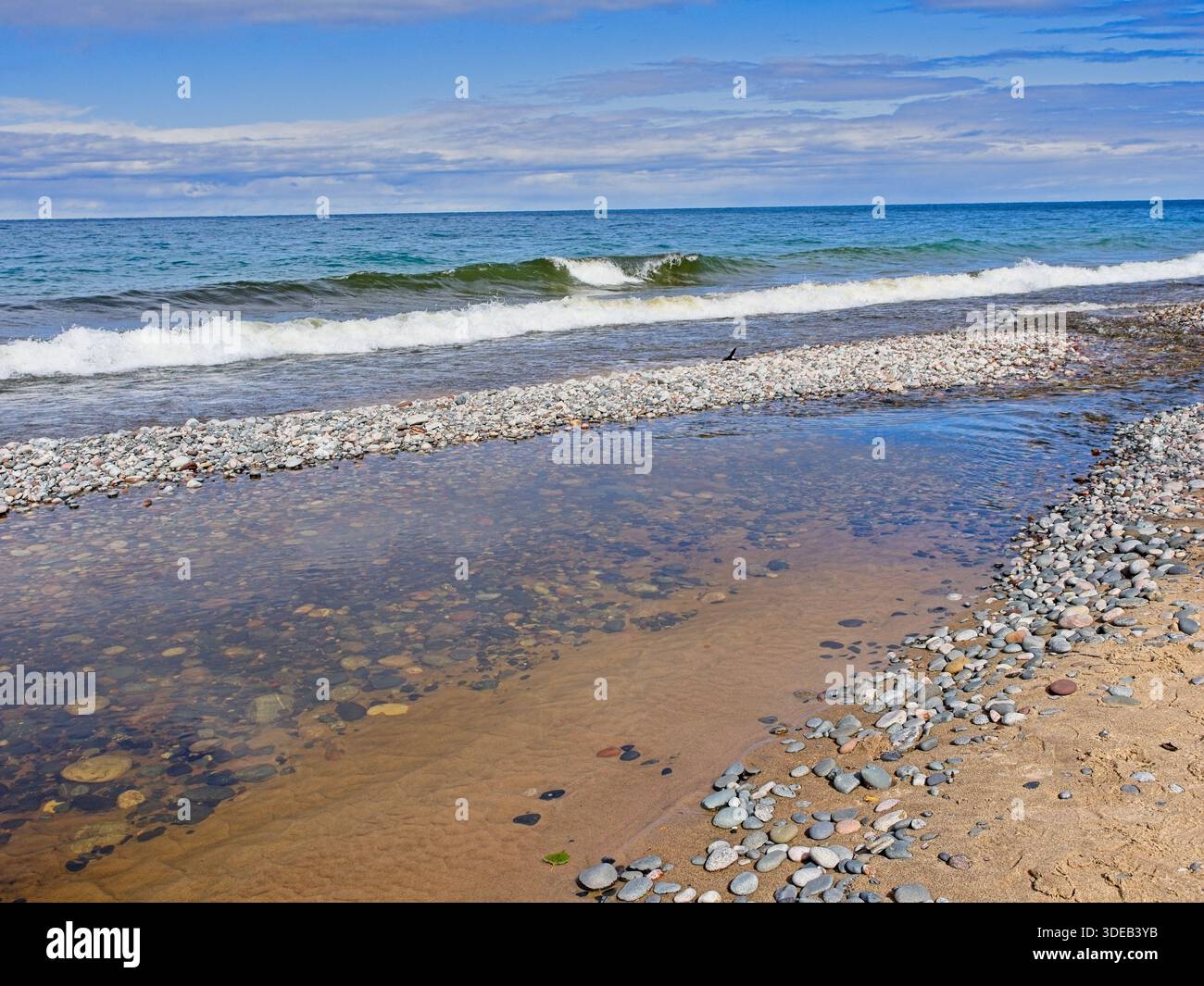 Lake Superior wave breaking on natural stone breakwater of Sable creek ...
