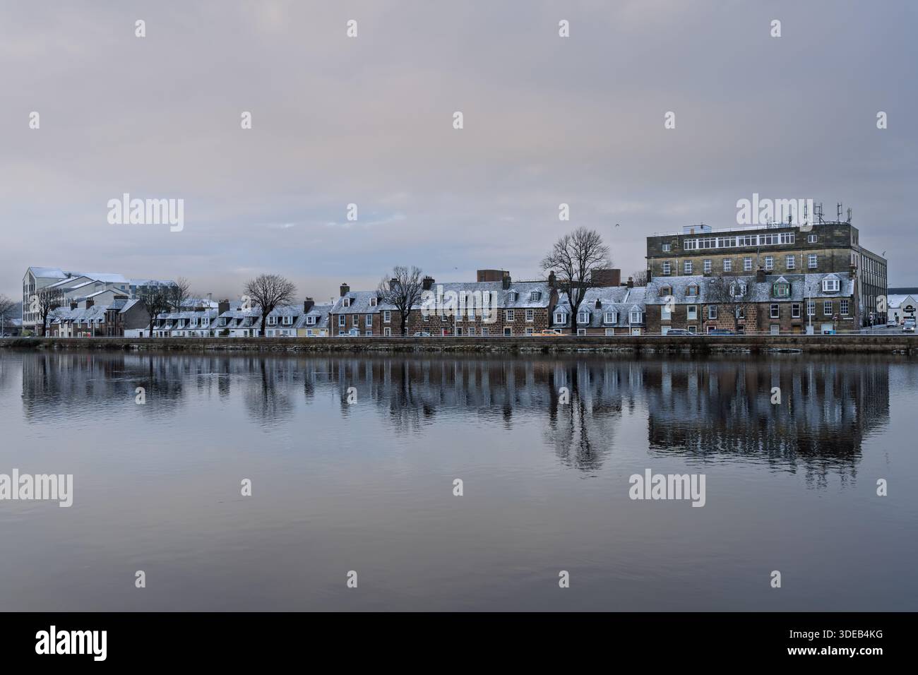 Inverness City Centre features snow on buildings along the River Ness ...