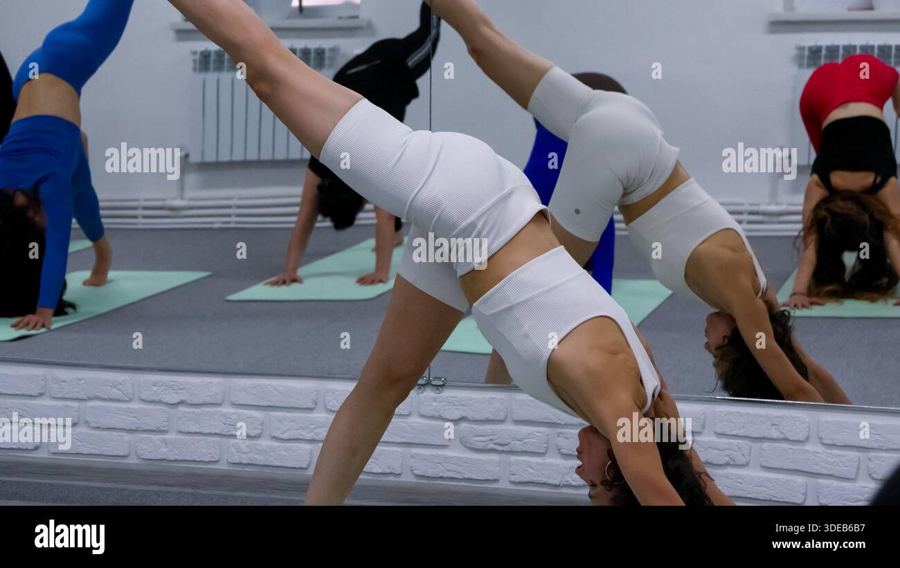 Group of women doing leg stretches and splits in class Stock Photo - Alamy