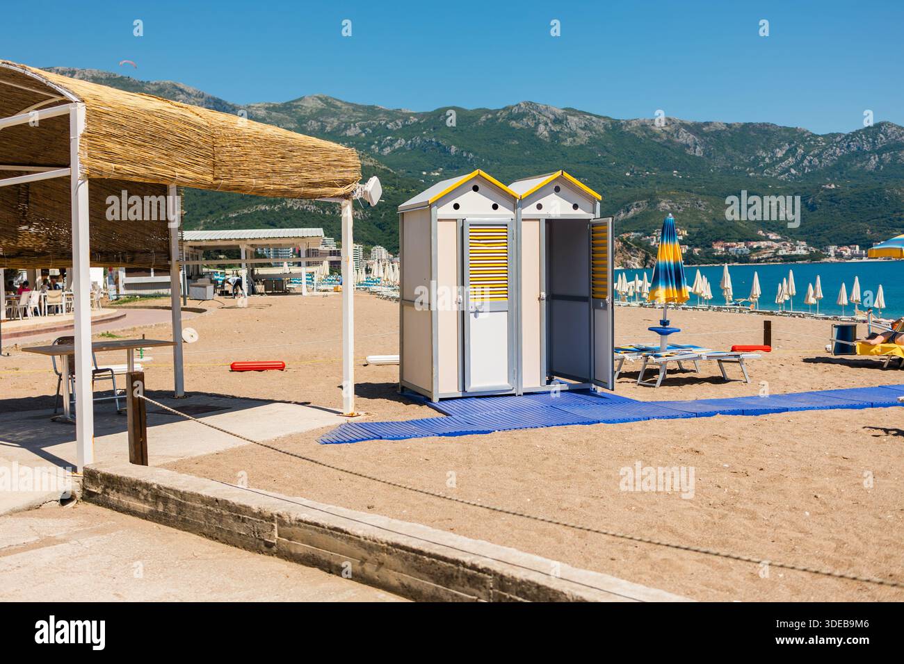 Beach changing cabins with accessible walkway near seaside shore ...