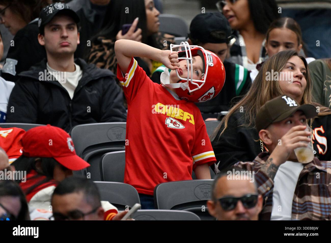 A young Kansas City Chiefs fan looks on during an NFL football game ...