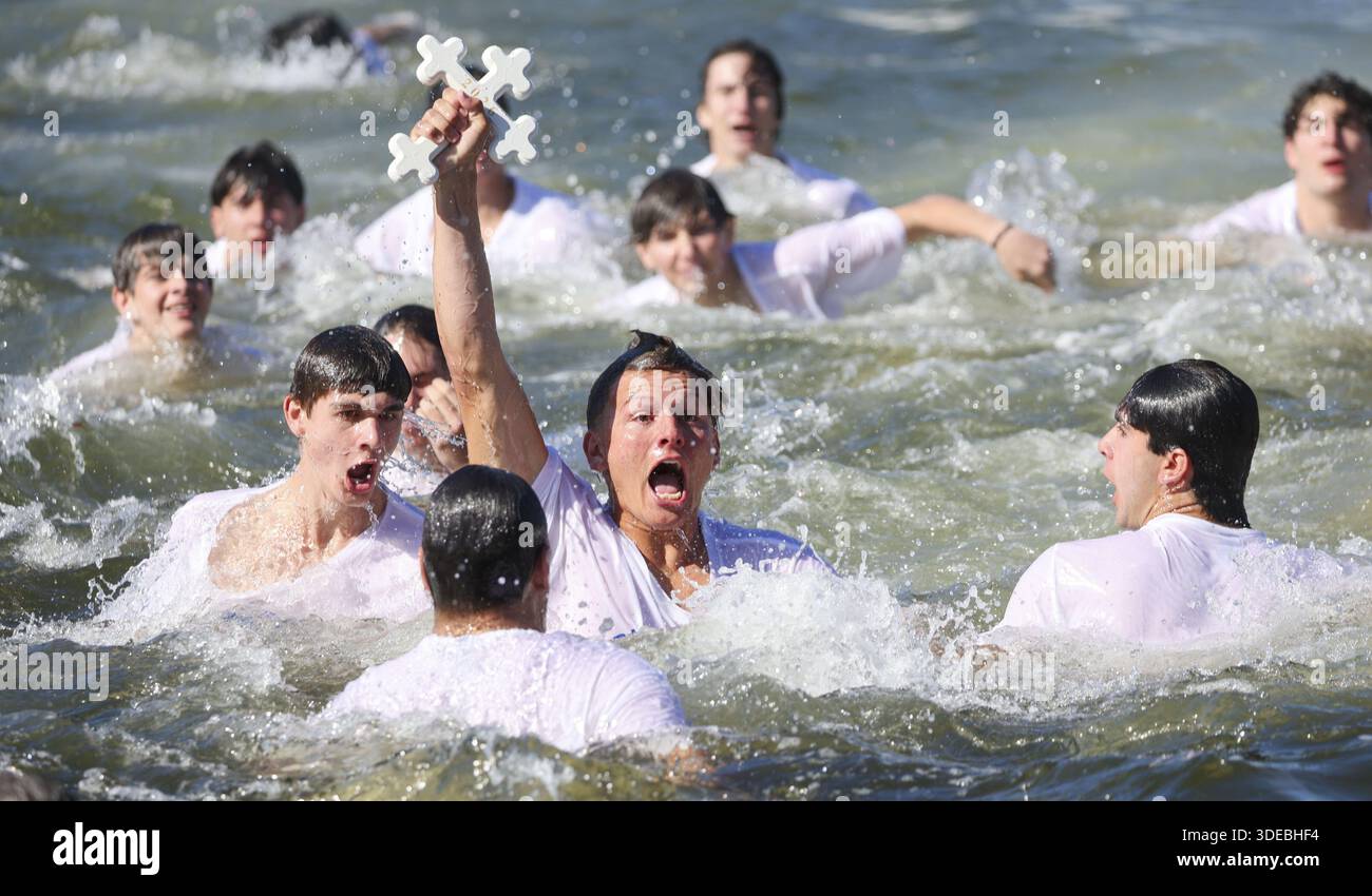 Athos Karistinos, 18, of Tarpon Springs, retrieves the cross from ...