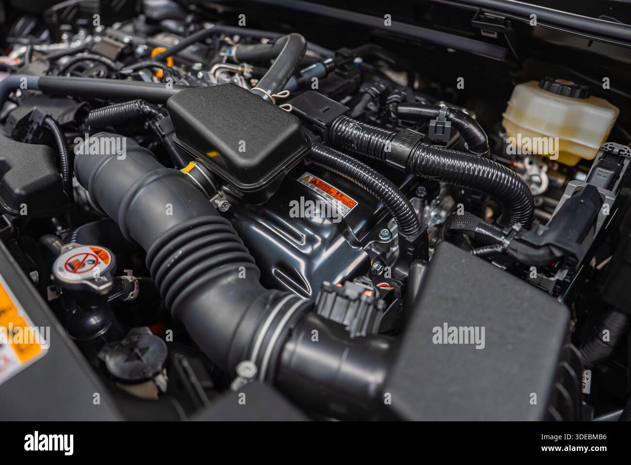 Clean car engine bay with glossy valve cover and intake tubing Stock ...