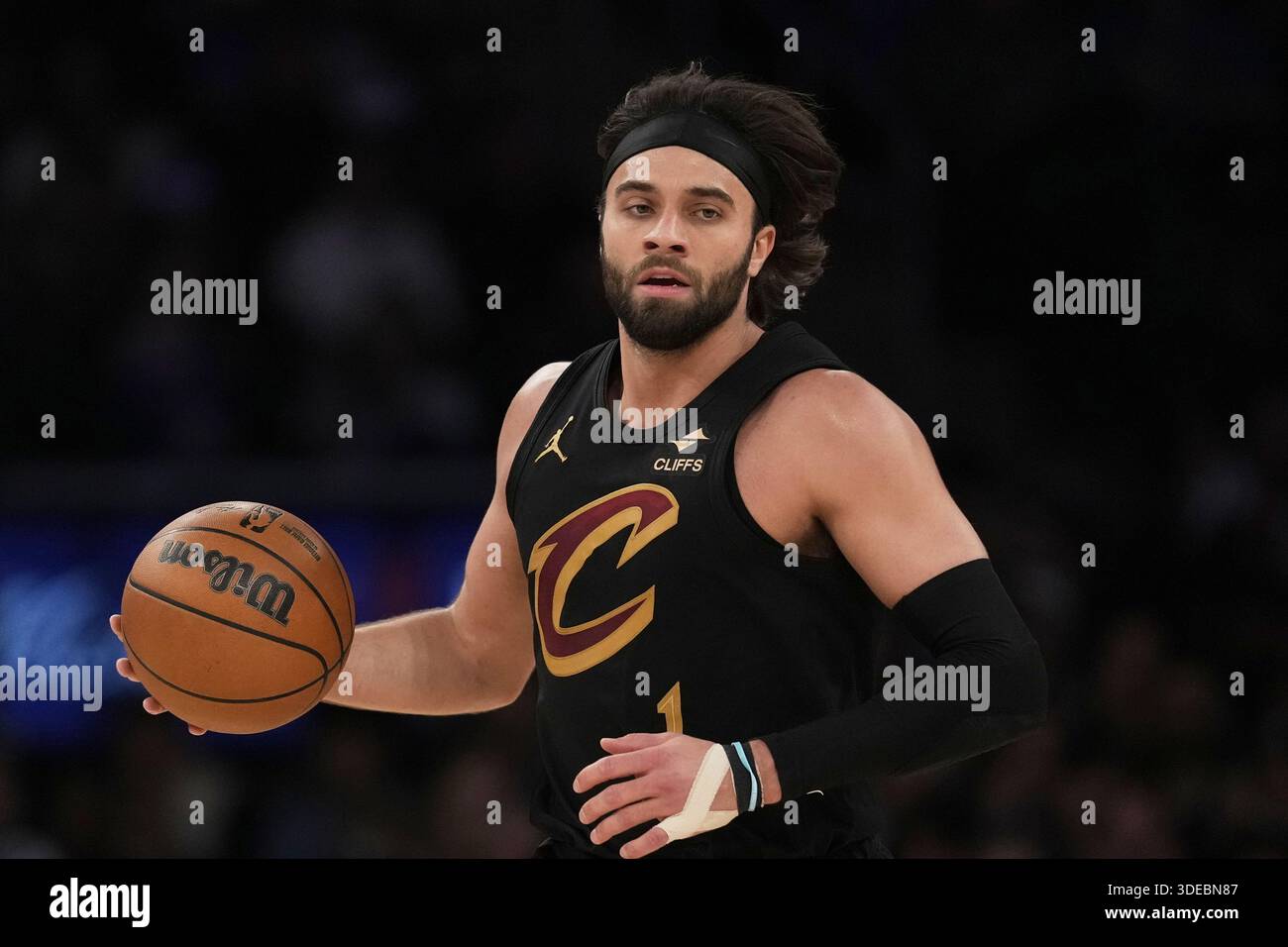 FILE - Cleveland Cavaliers' Max Strus dribbles during the first half of ...