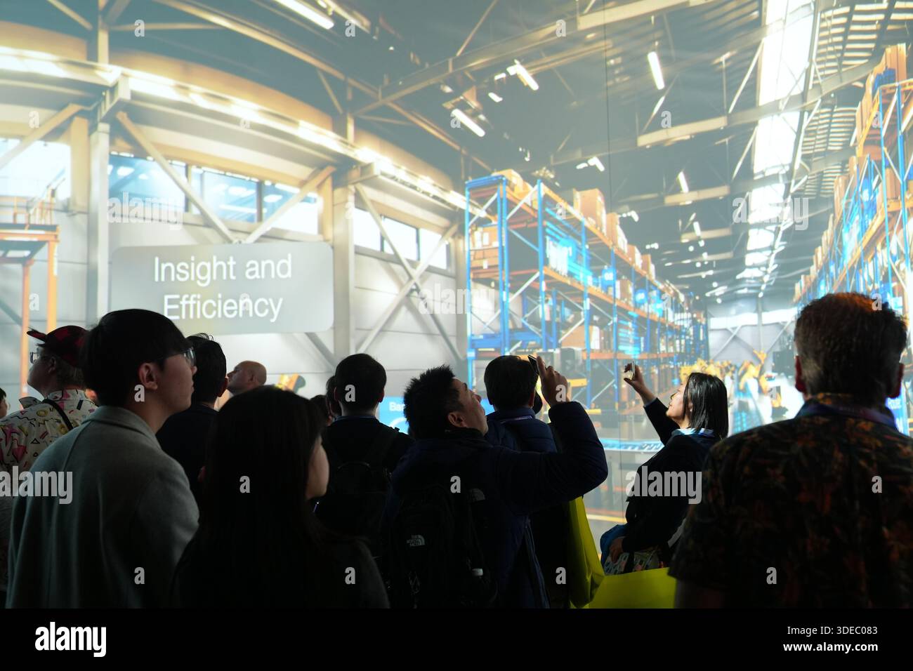 People watch a short film at the Panasonic booth during the CES tech ...