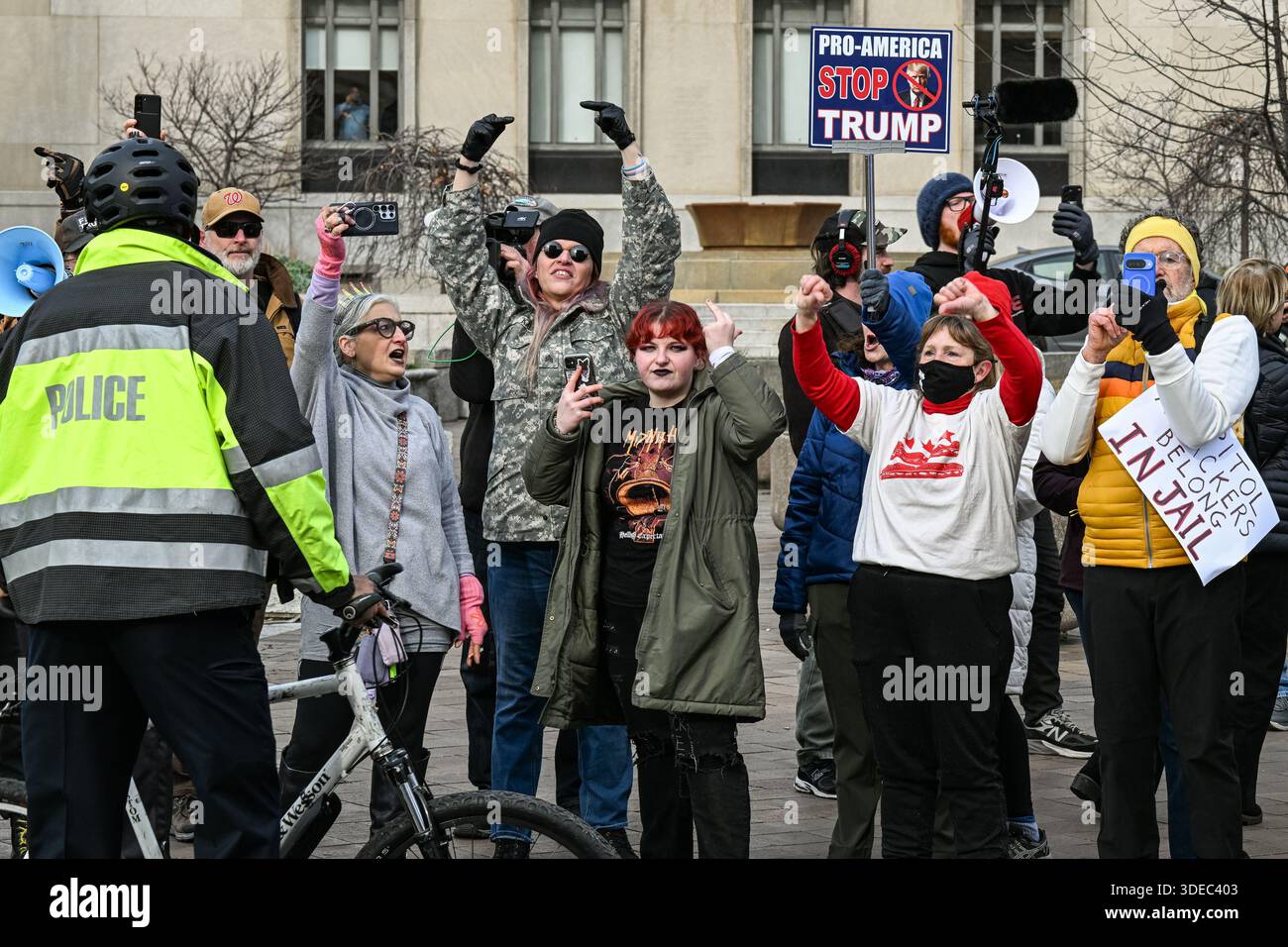 A line of police officers separates counter-protesters from January 6 ...