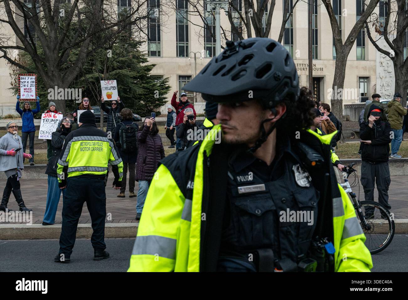 A line of police officers separates counter-protesters from January 6 ...
