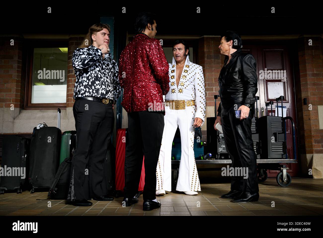 Fans dressed as Elvis Presley wait for the departure of the Elvis ...