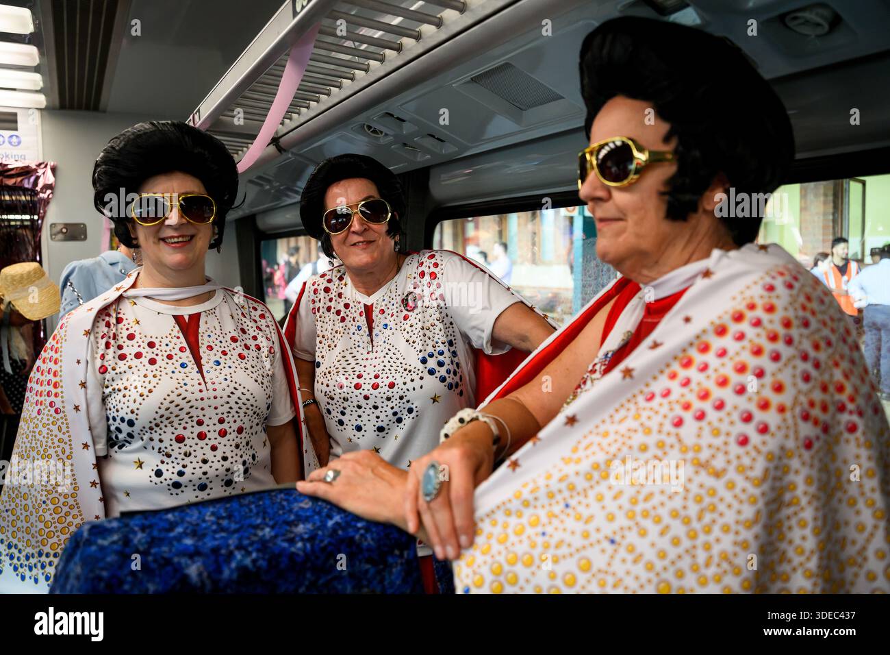 Fans dressed as Elvis Presley wait for the departure of the Elvis ...
