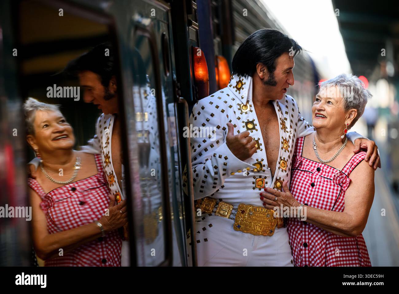 A fan dressed as Elvis Presley waits for the departure of the Elvis ...