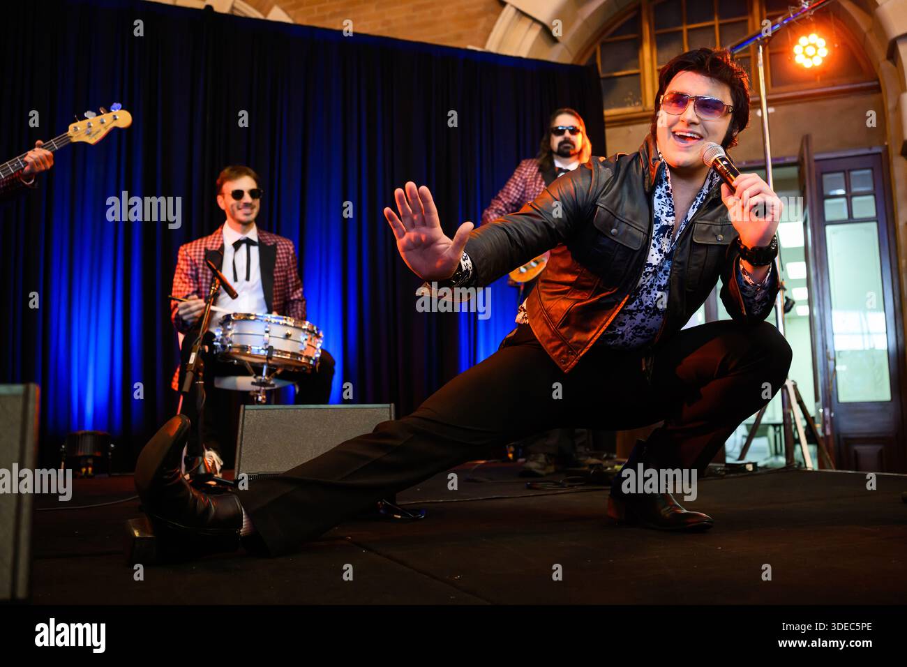 A fan dressed as Elvis Presley performs ahead of the departure of the ...