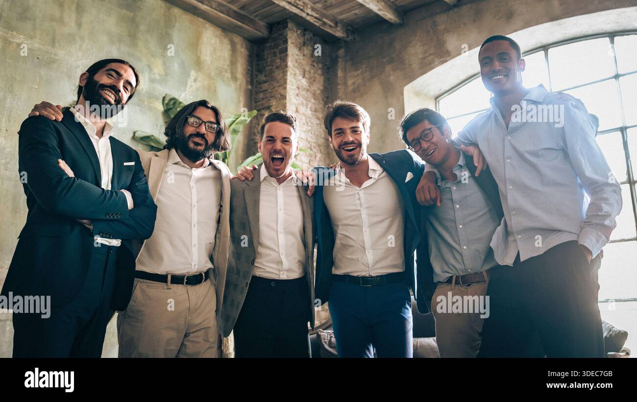 A diverse group of business men standing together in a modern office ...