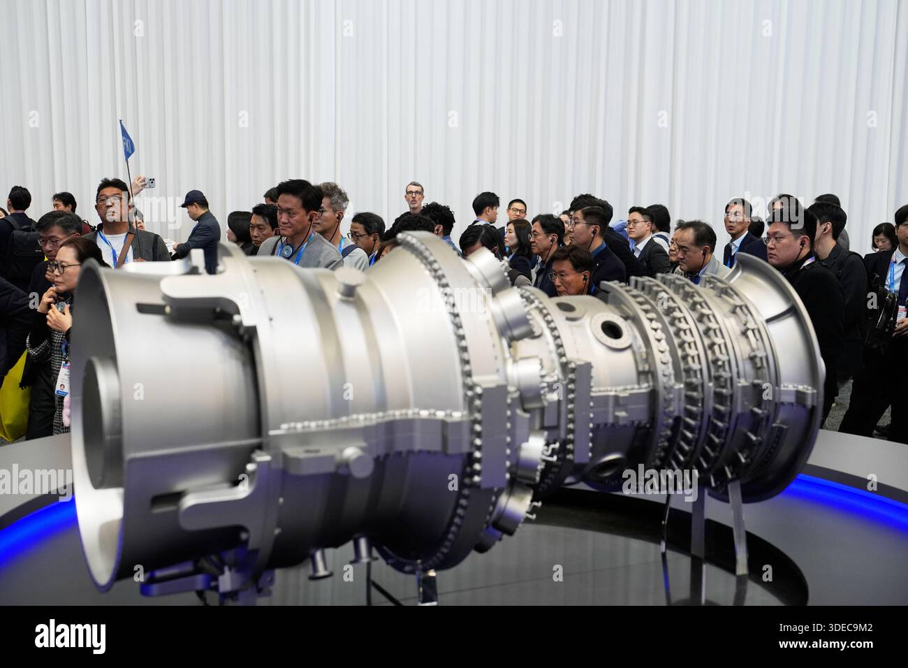 People pass a model of an engine at the the Doosan booth during the CES ...