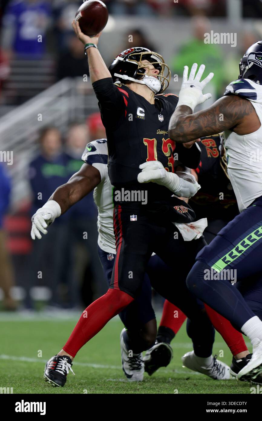 San Francisco 49ers quarterback Brock Purdy (13) is hit by Seattle ...