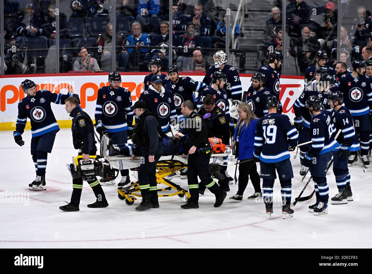 Winnipeg Jets' Haydn Fleury is helped off the ice after being injured ...