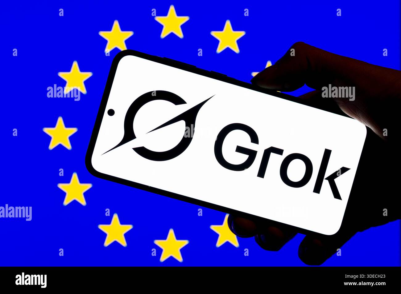 The Grok logo is displayed on a mobile phone with the EU flag visible ...