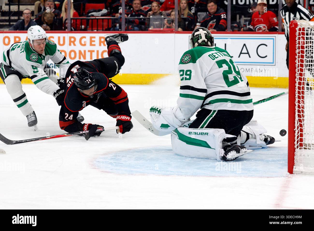 Carolina Hurricanes' Seth Jarvis (24) gets taken down by Dallas Stars ...