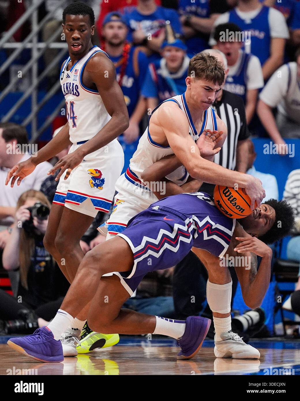 TCU guard Jace Posey, front, and Kansas guard Kohl Rosario, back ...