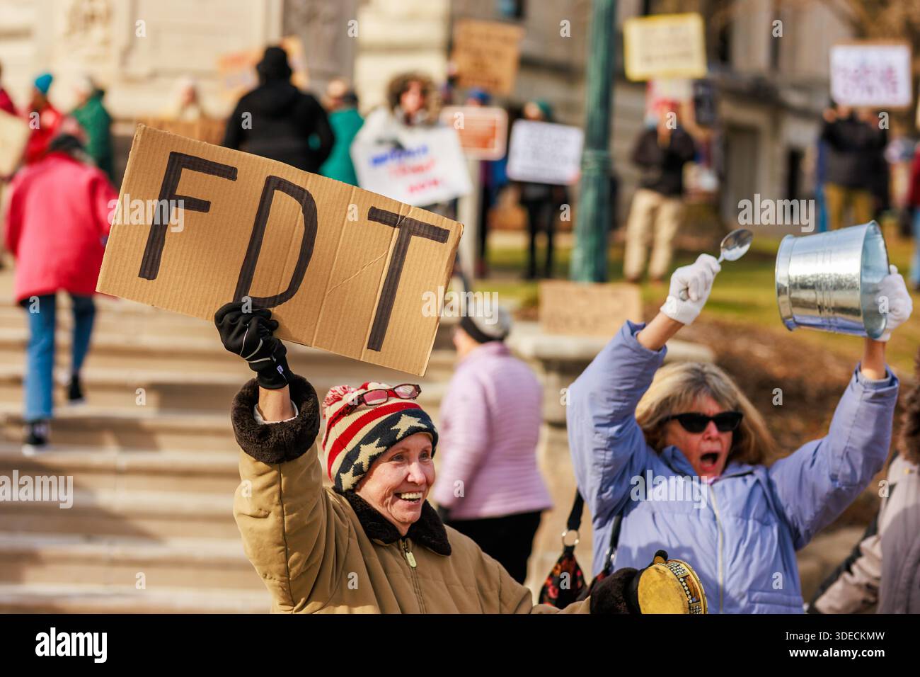 A protester holds a sign reading, “FDT,” during a protest against the ...