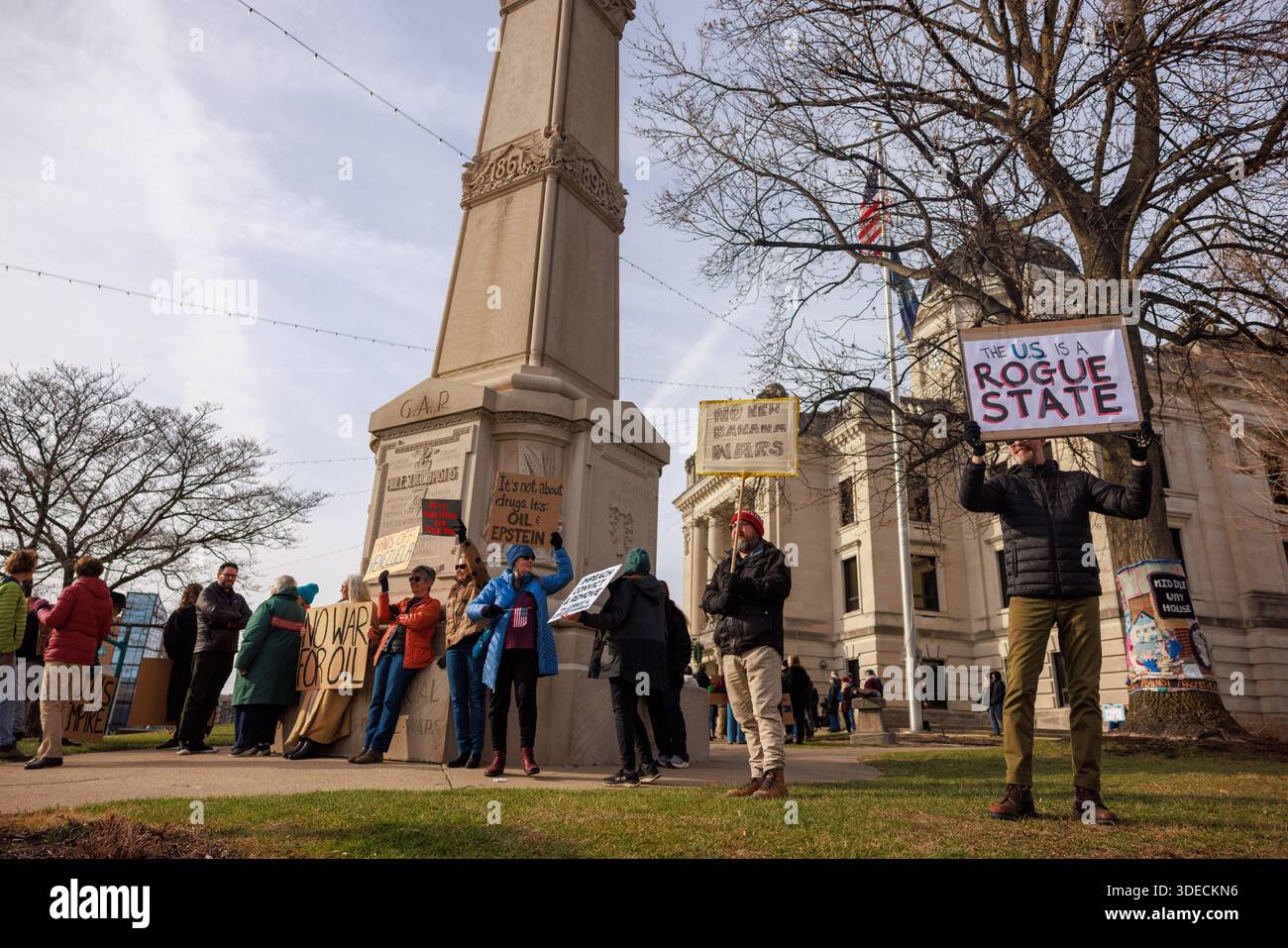 A protester holds a sign reading “The U.S. is a rogue state,” during a ...