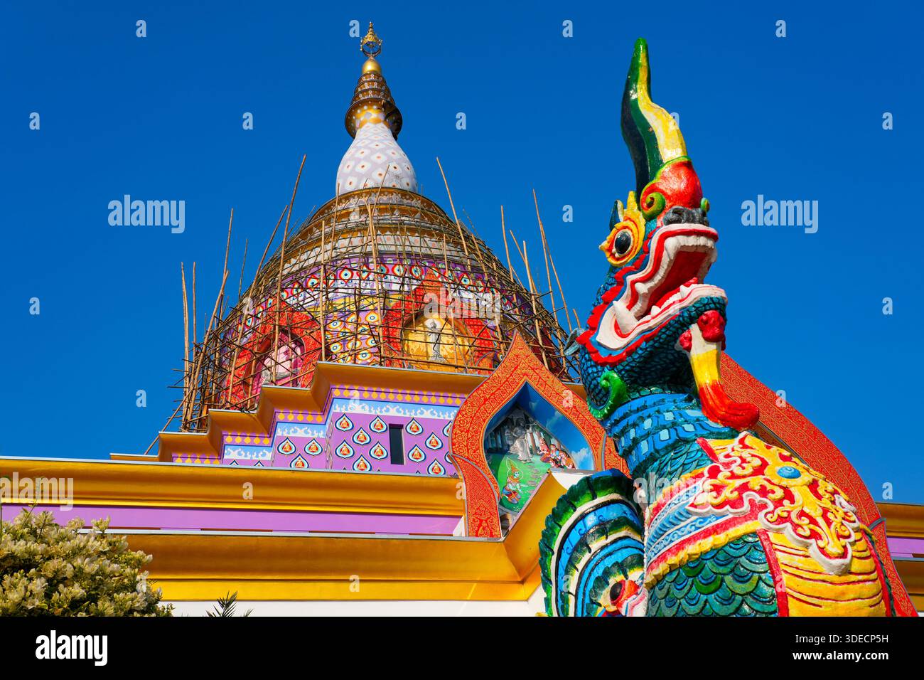 Colorful mythical Naga statue in front of the crystal pagoda of Wat Tha ...
