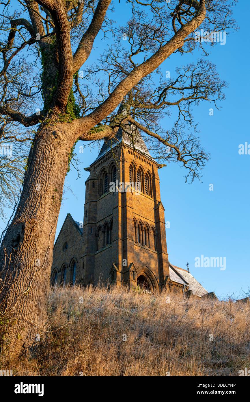 St. Peter and St. Pauls Church in snow at sunrise. Winderton, Cotswolds ...