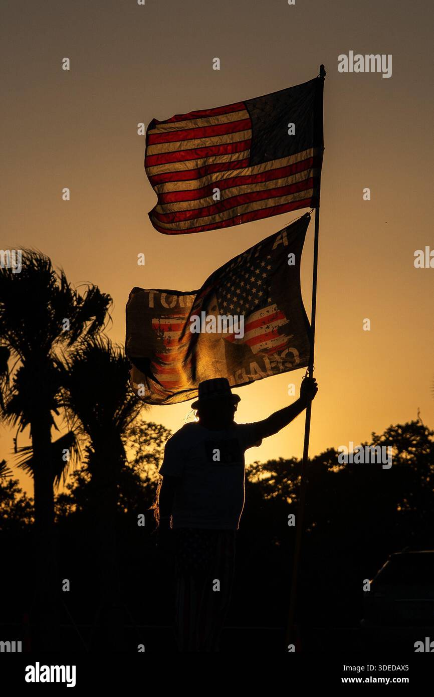 FILE - Steve Emery holds flags in tribute to right-wing political ...