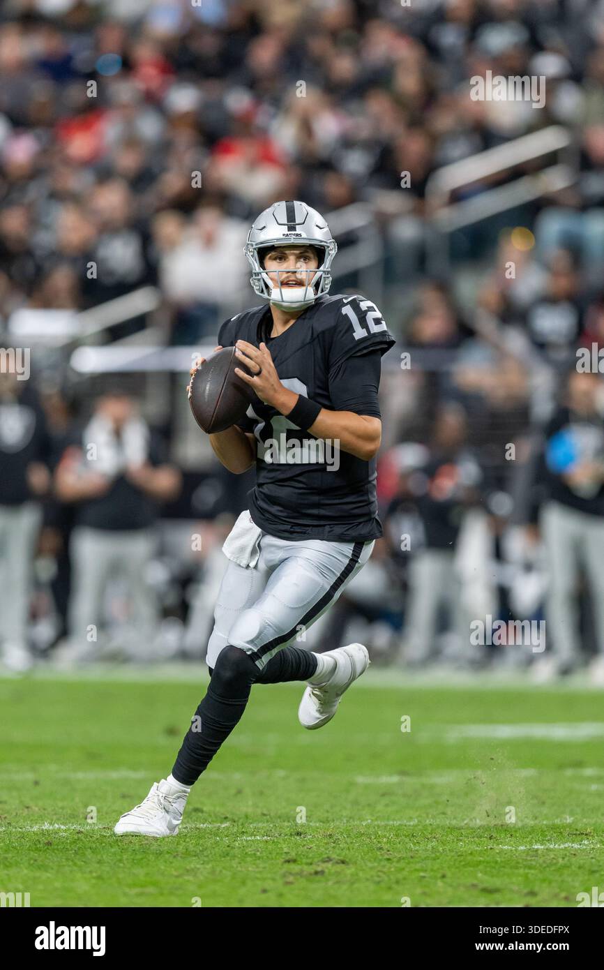 Las Vegas Raiders quarterback Aidan O'Connell (12) rolls out against ...