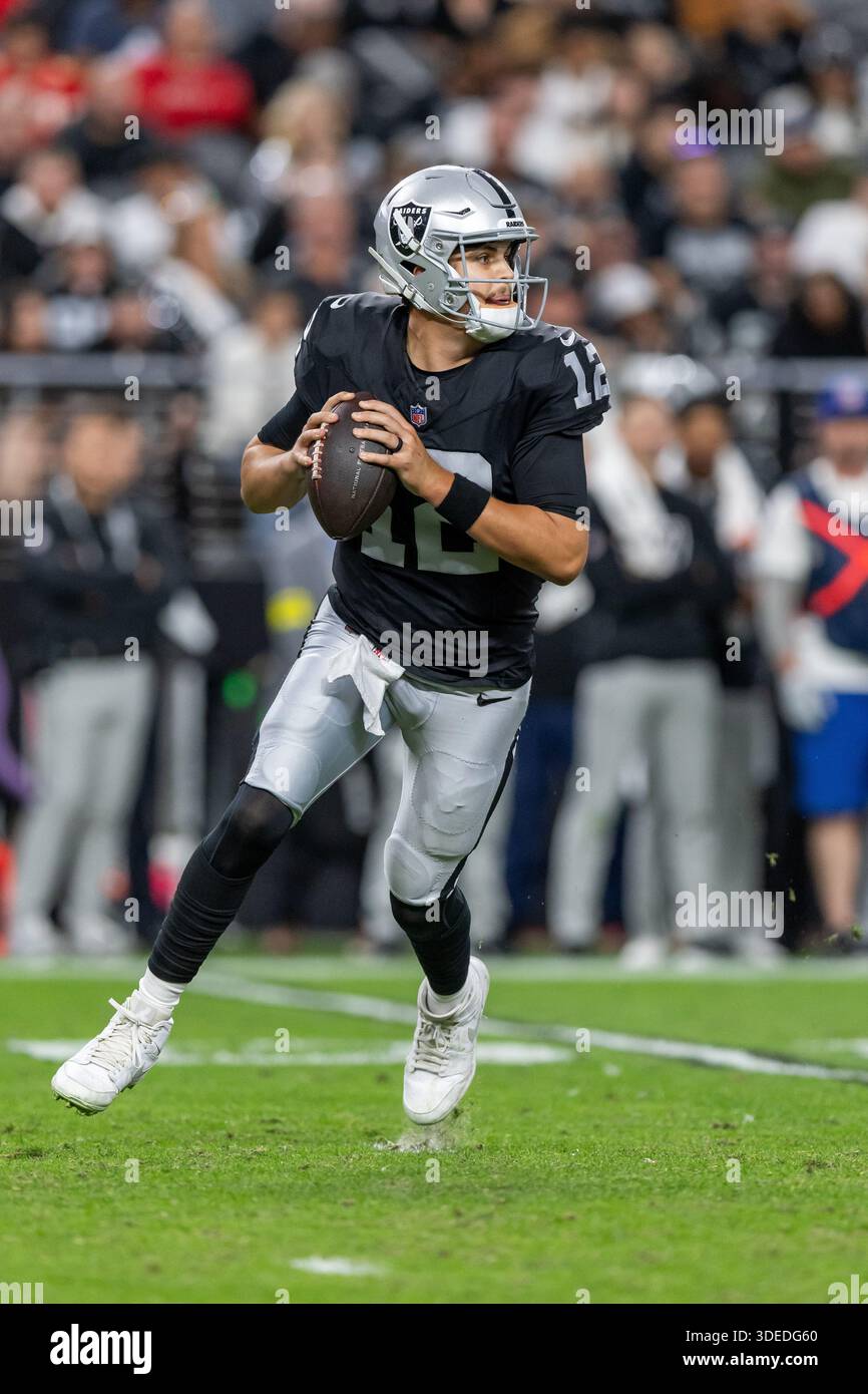 Las Vegas Raiders quarterback Aidan O'Connell (12) rolls out against ...