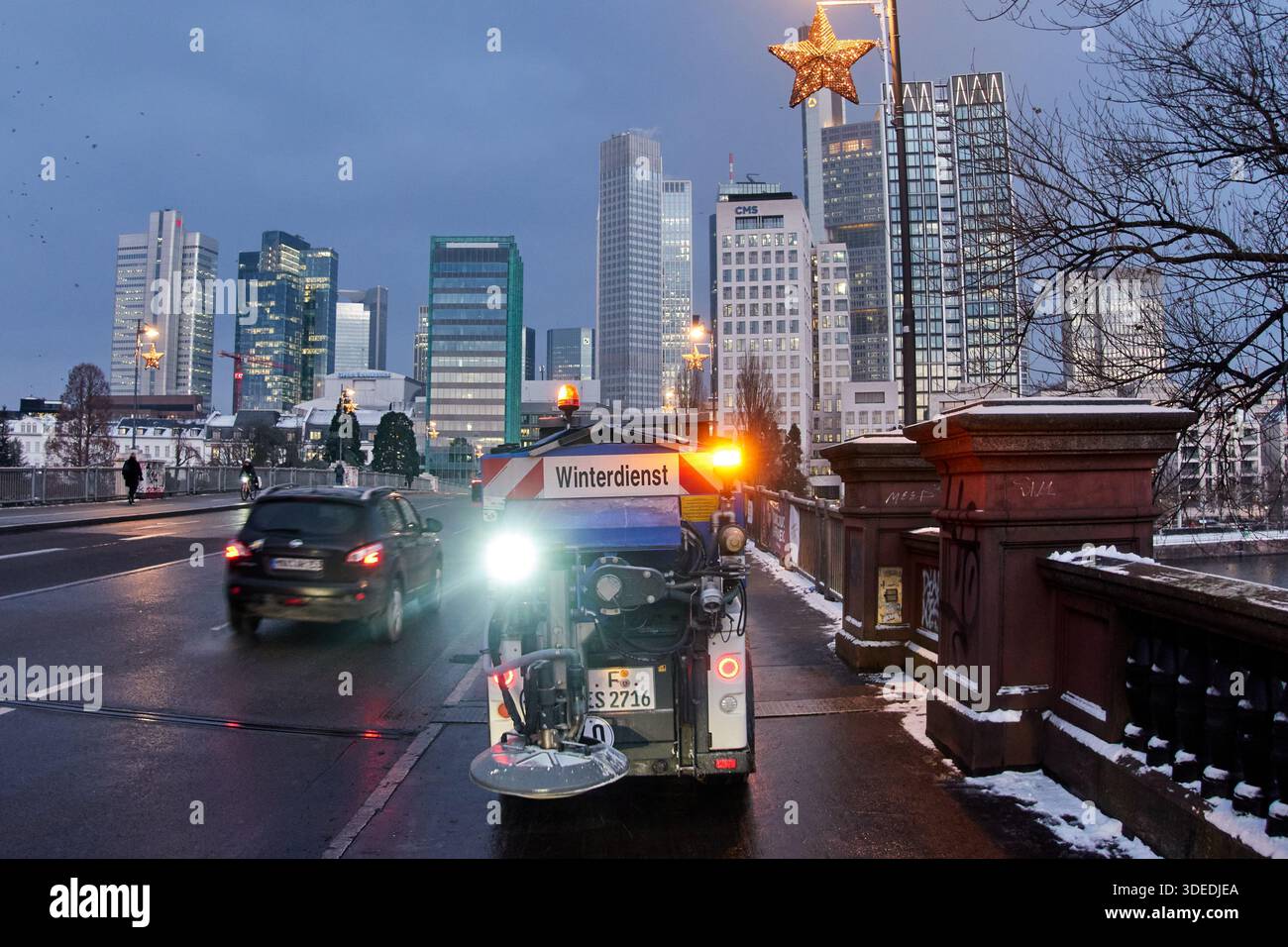 A gritting vehicle puts salt on the street in Frankfurt, Germany ...