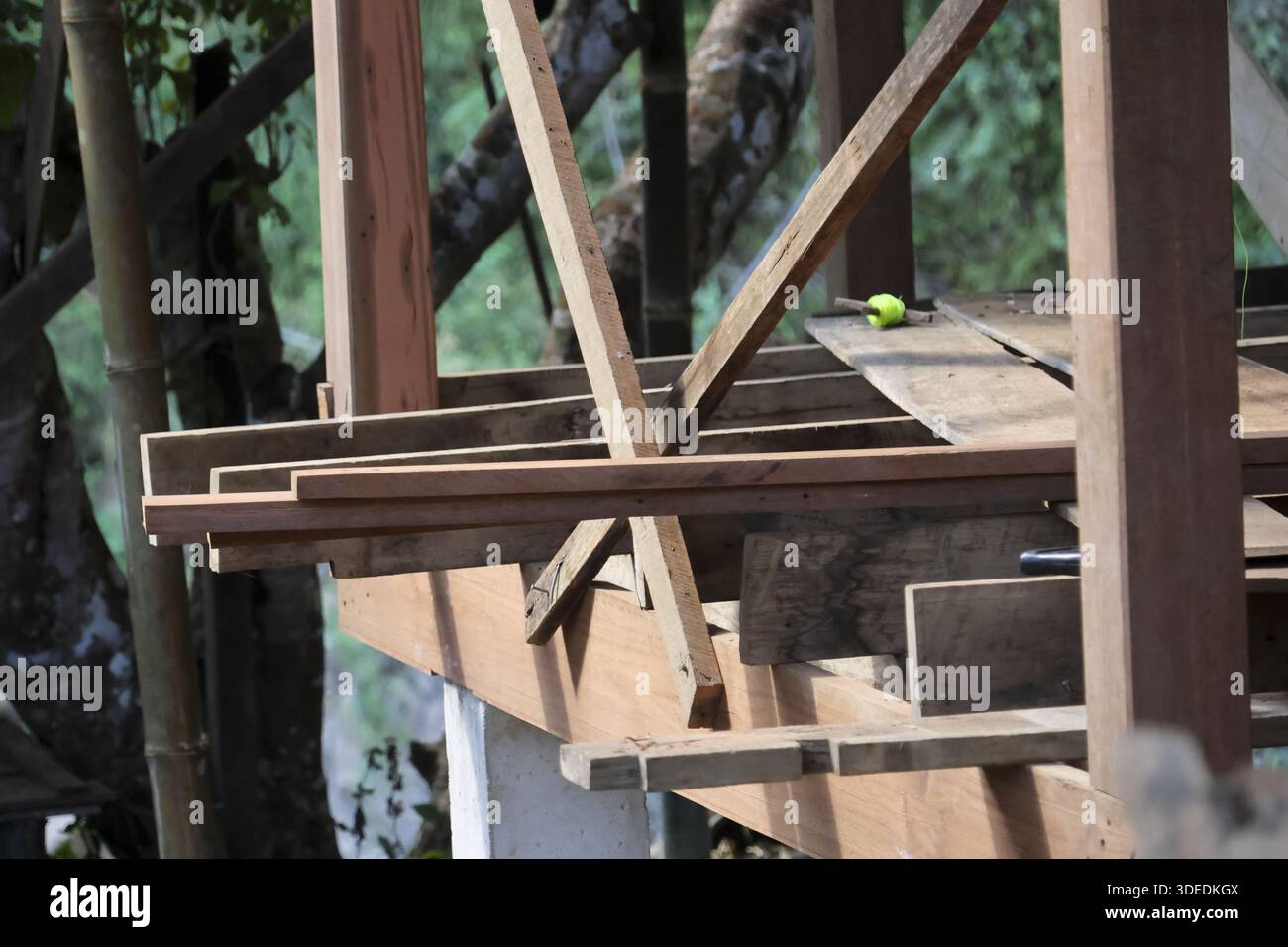 Unfinished wooden house structure with beams and planks under ...