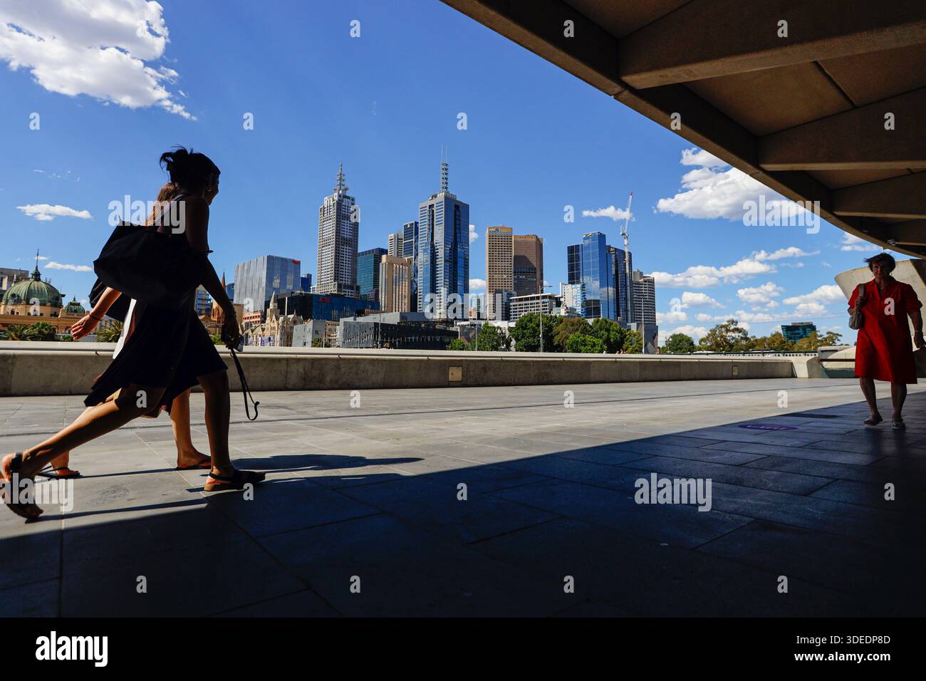 People walking and seeking shade are seen in a general city view during ...