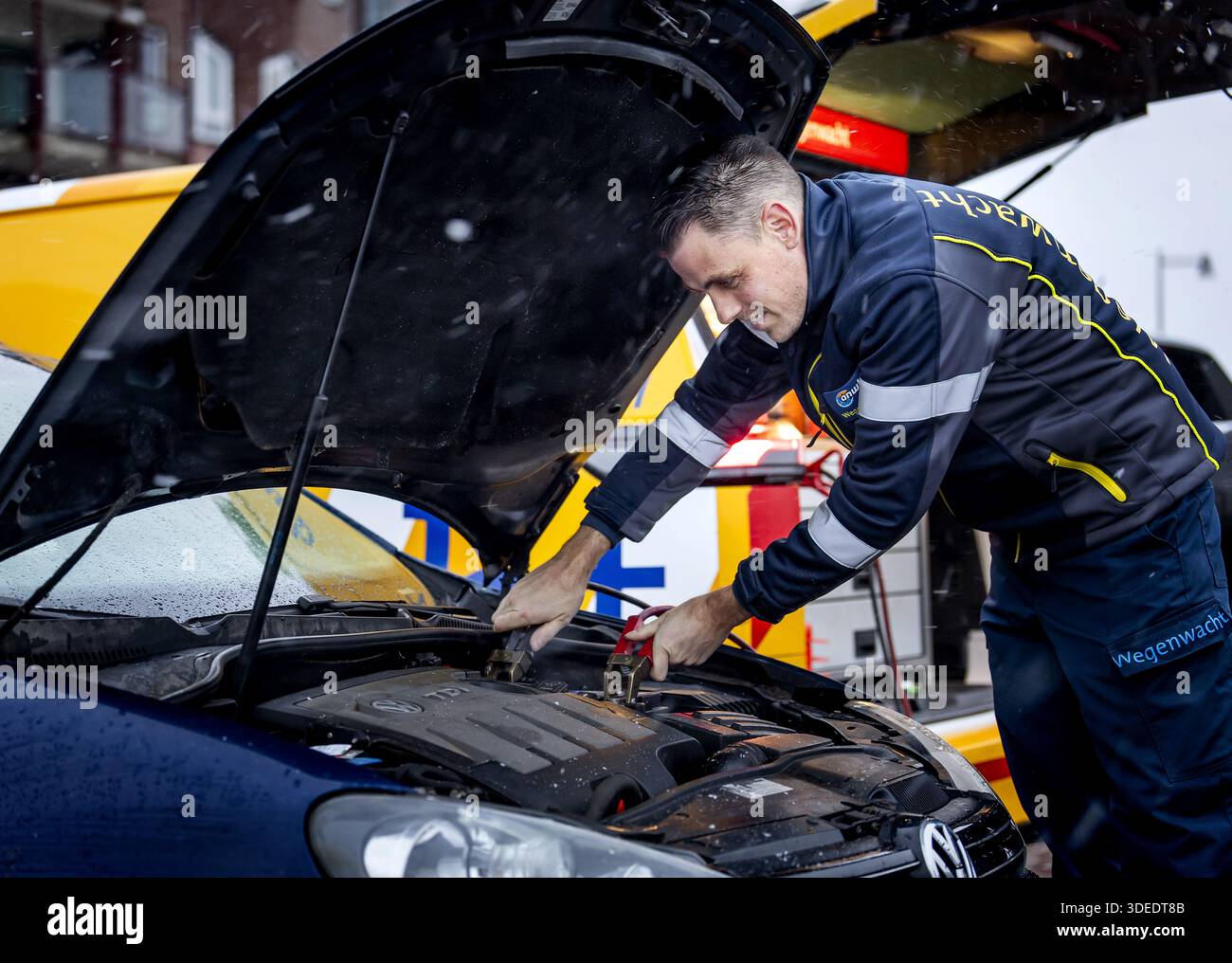EGMOND AAN ZEE - An ANWB roadside assistance worker attends to a ...