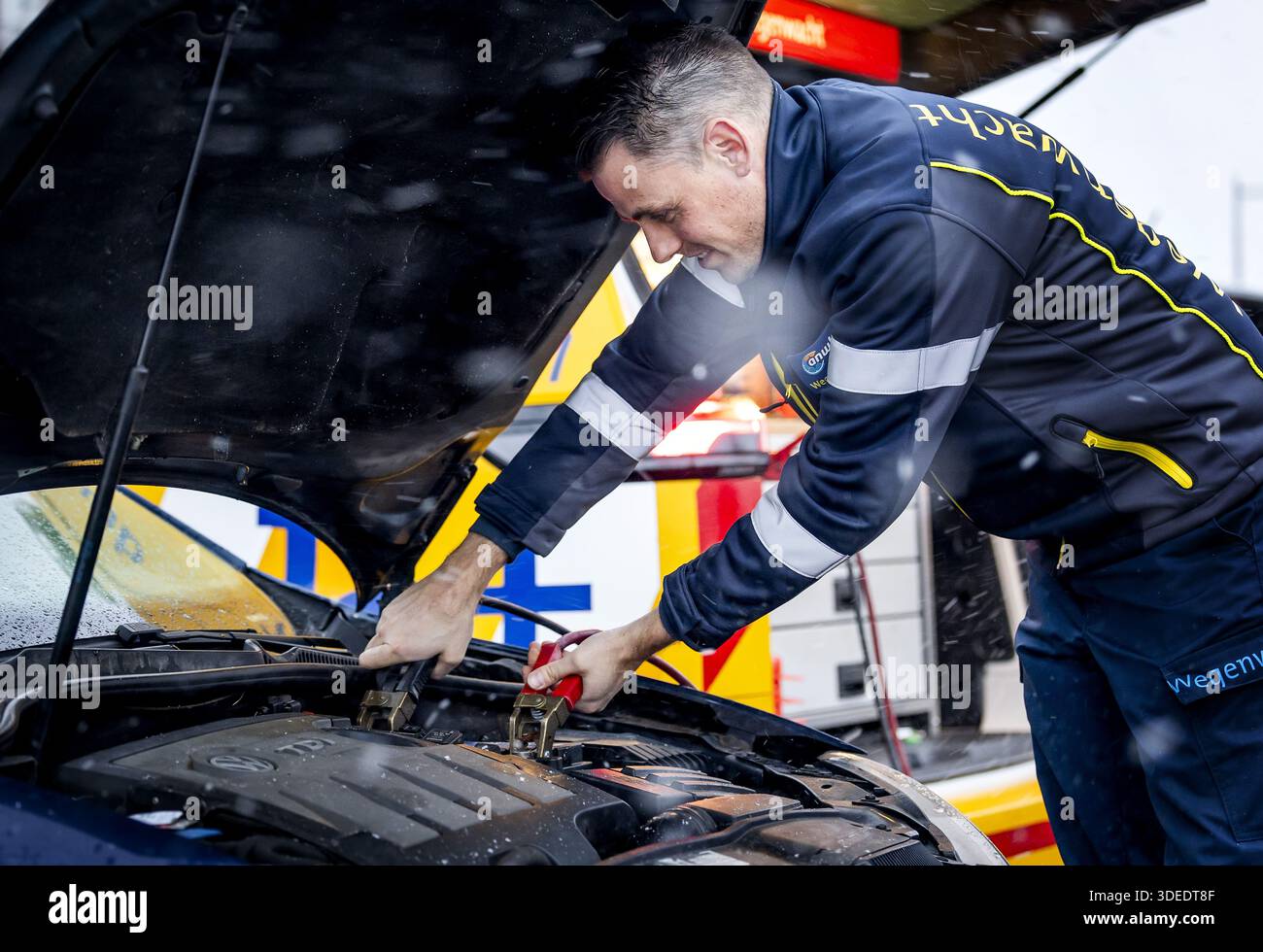 EGMOND AAN ZEE - An ANWB roadside assistance worker attends to a ...