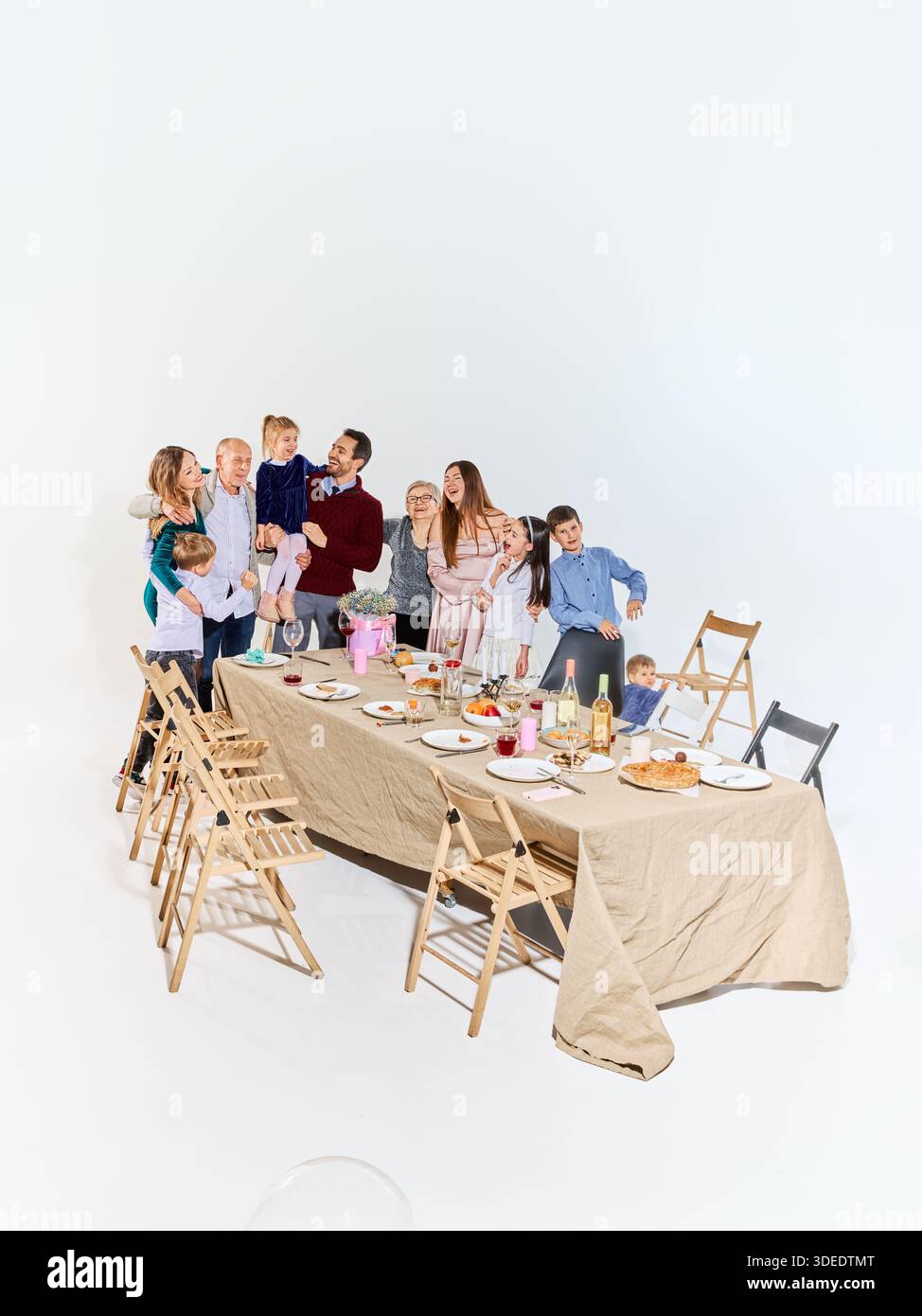 Family gathering around festive table hi-res stock photography and ...