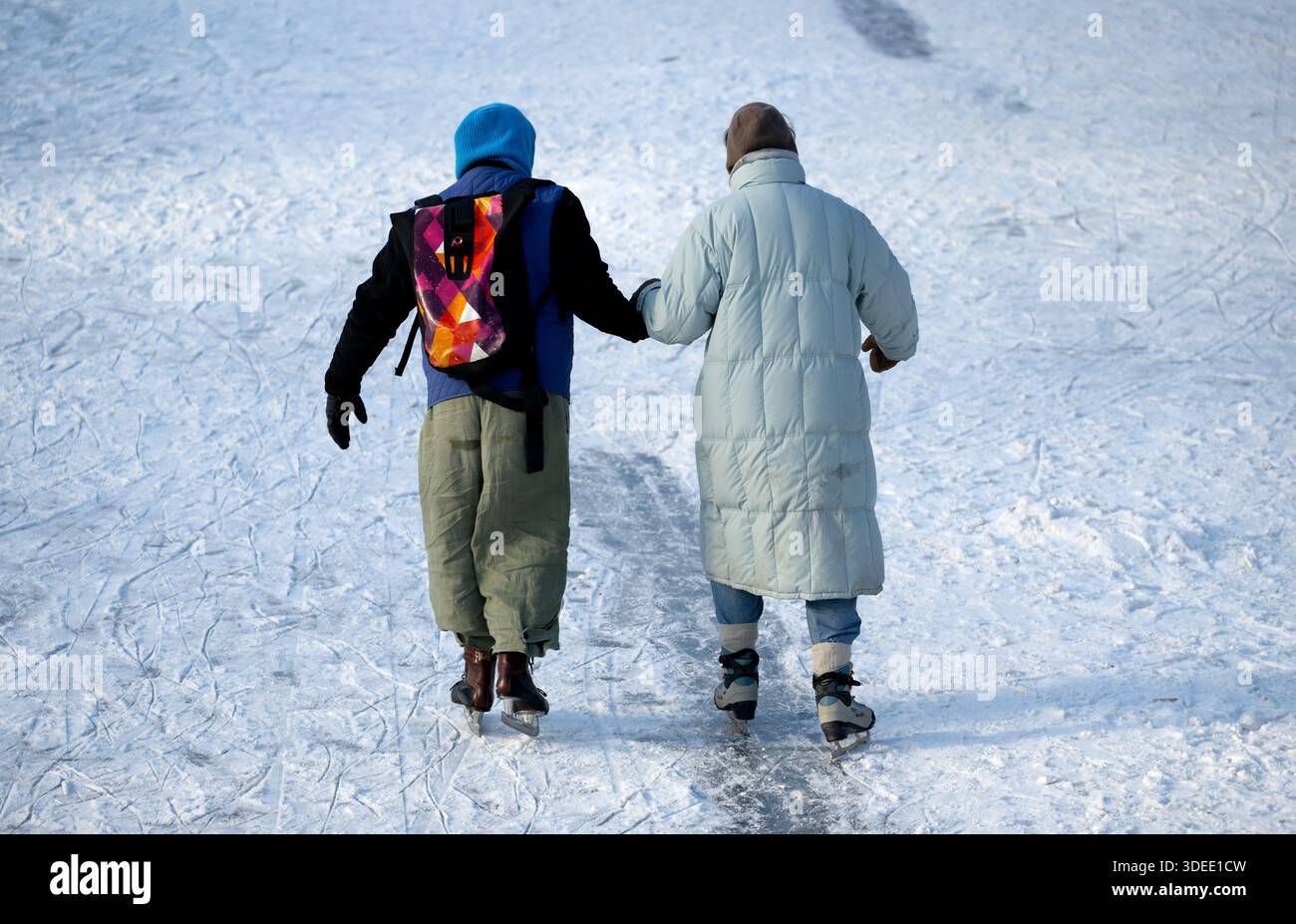 Munich, Germany. 07th Jan, 2026. A man and a woman skate across the ...