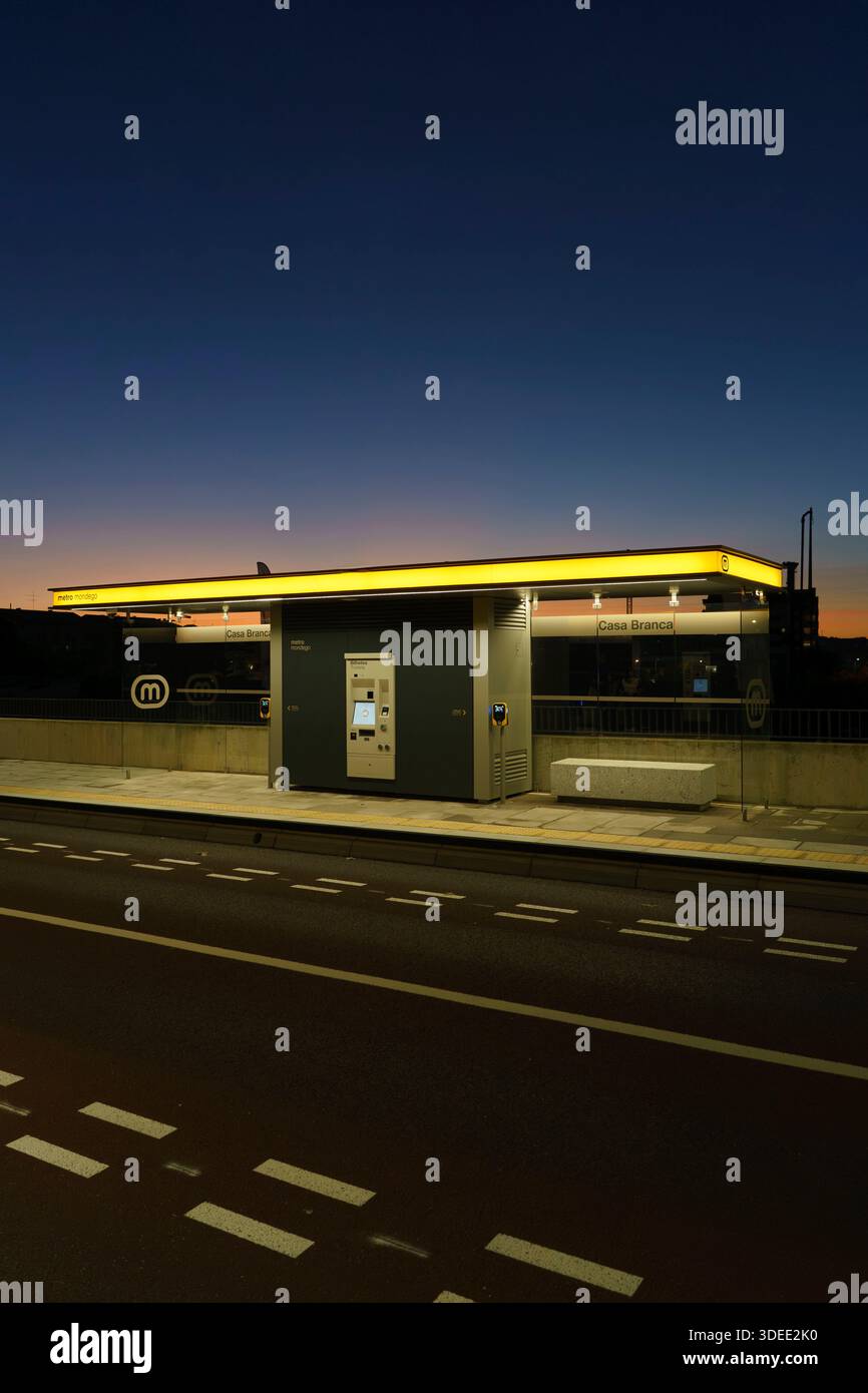 Modern metro bus stop with illuminated ticket machine on an empty ...