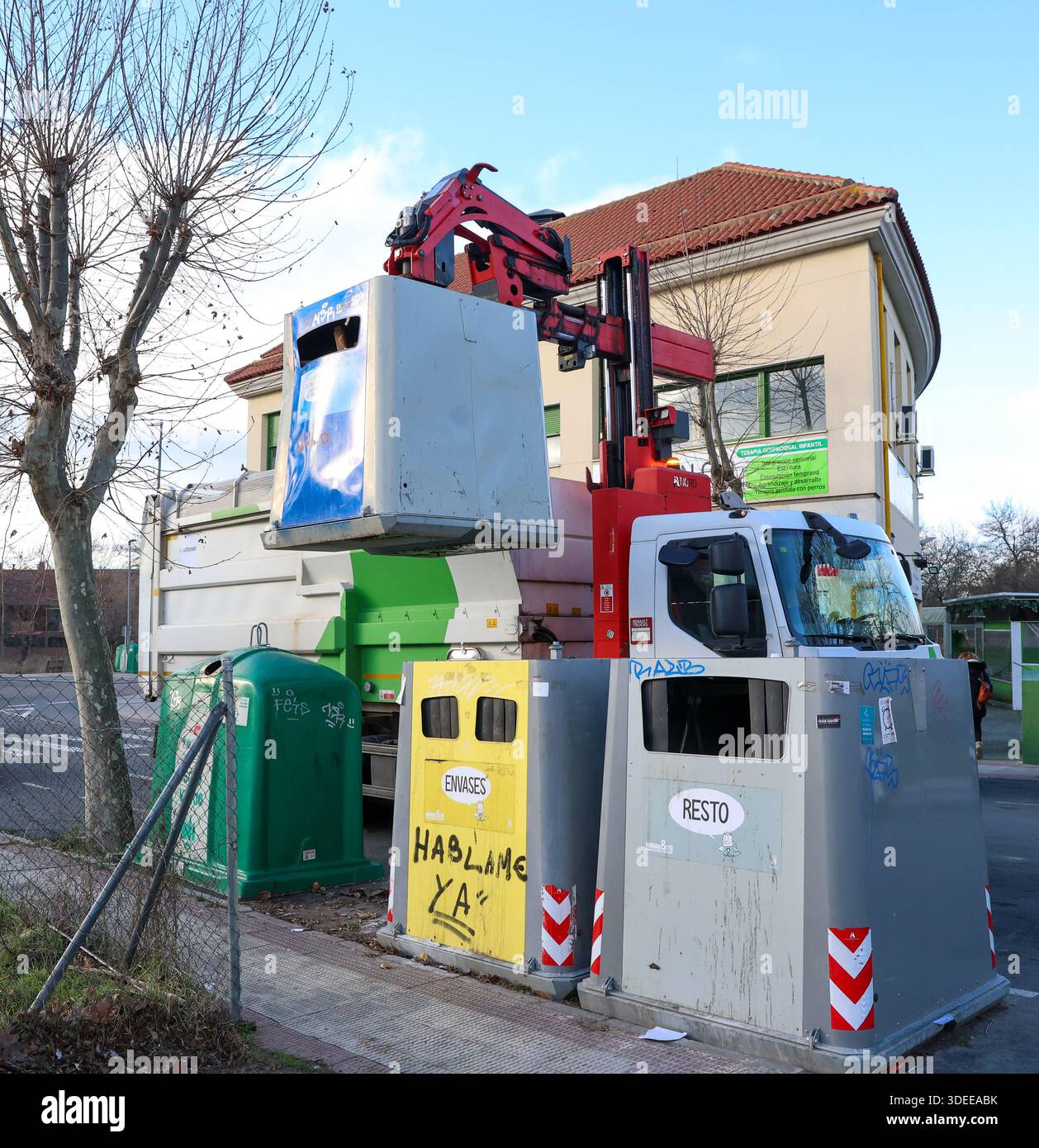 A truck empties a garbage container on January 7, 2026, in Madrid ...